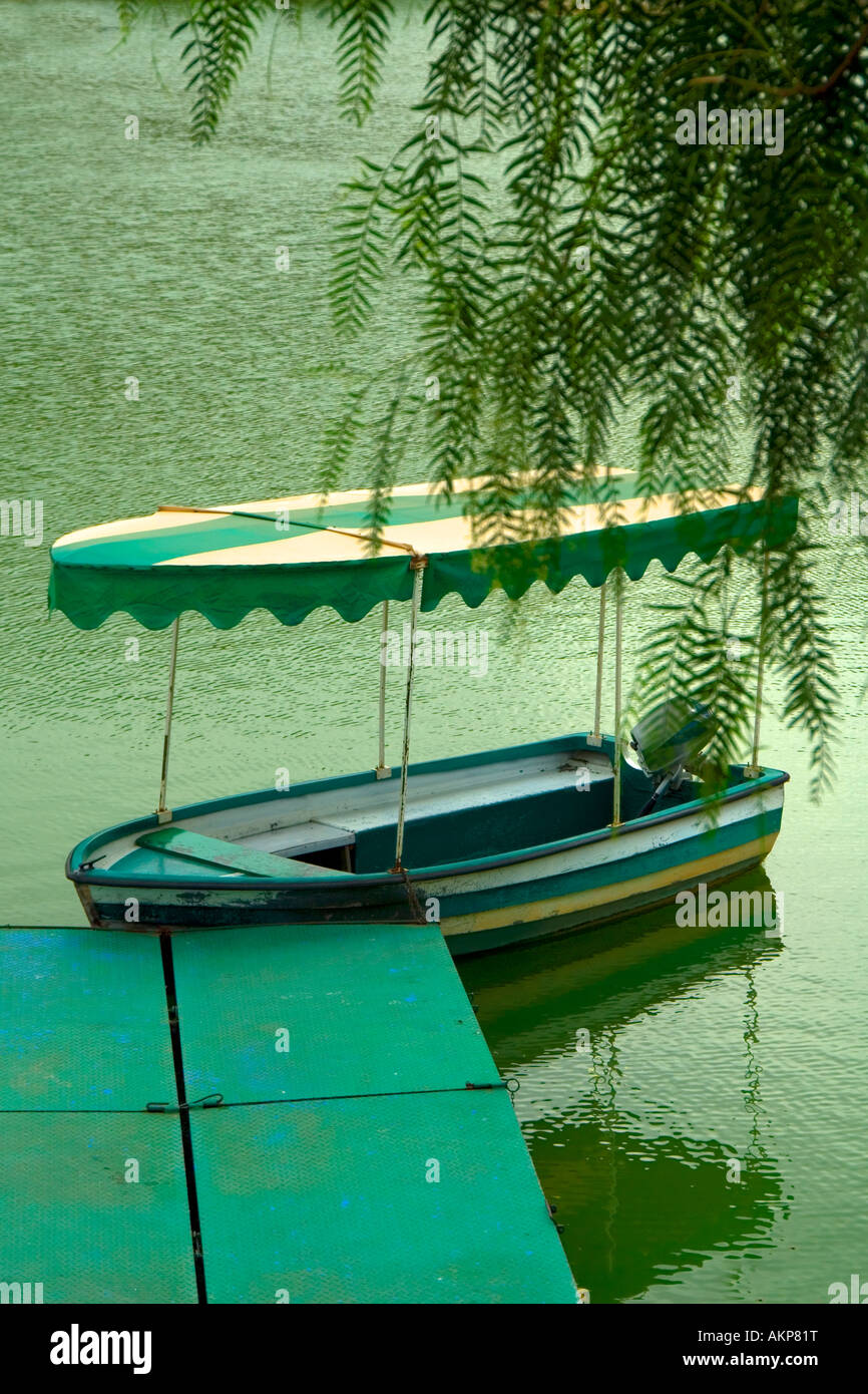 Empty boat by the dock in a lake Stock Photo - Alamy