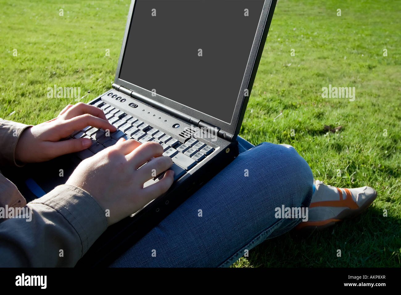Young woman typing in the computer outdoors Stock Photo - Alamy