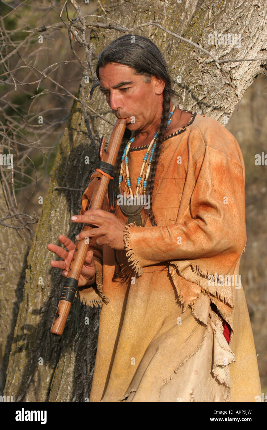 A Native American Indian man playing a musical flute Stock Photo - Alamy