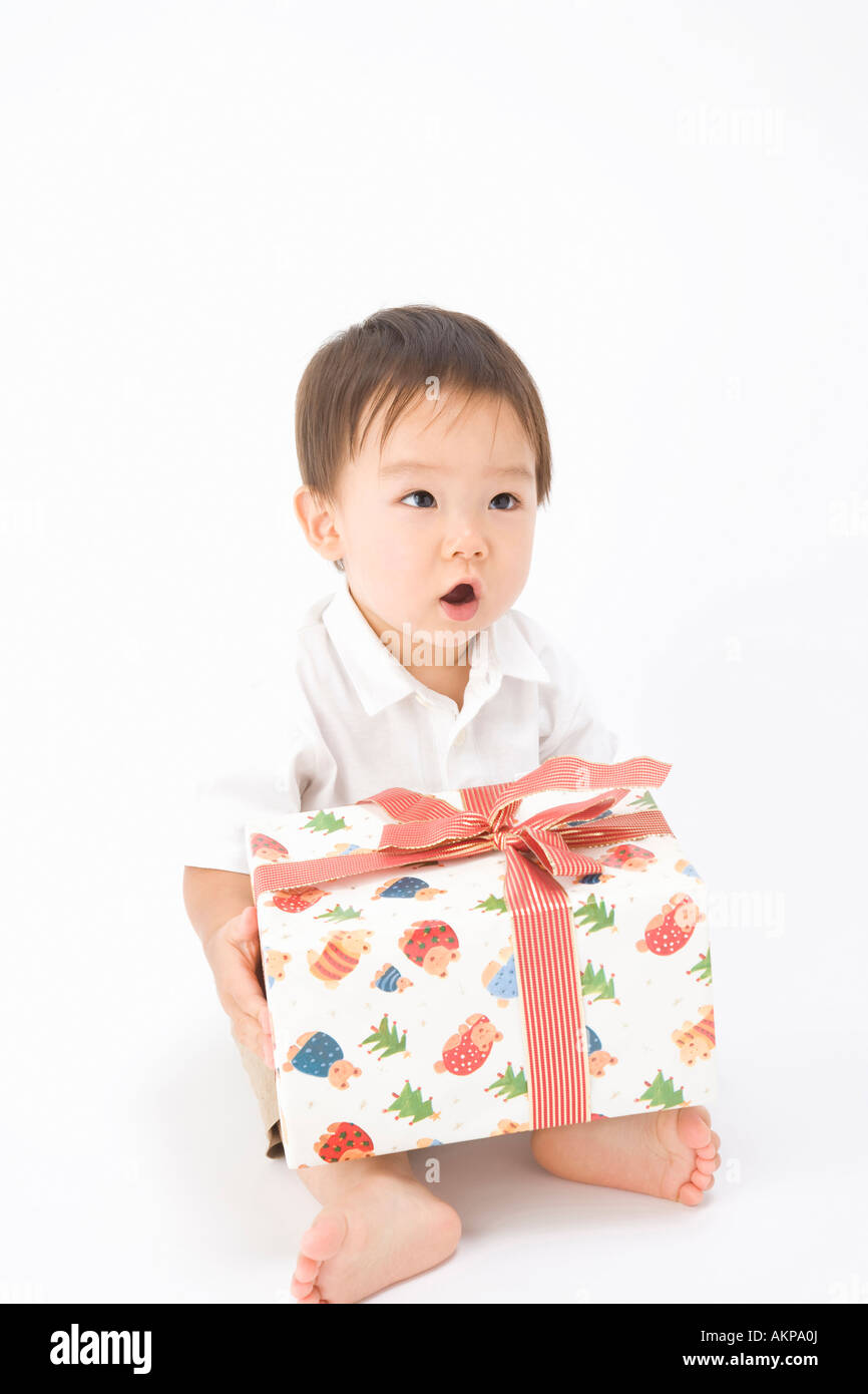 Baby with a present Stock Photo - Alamy
