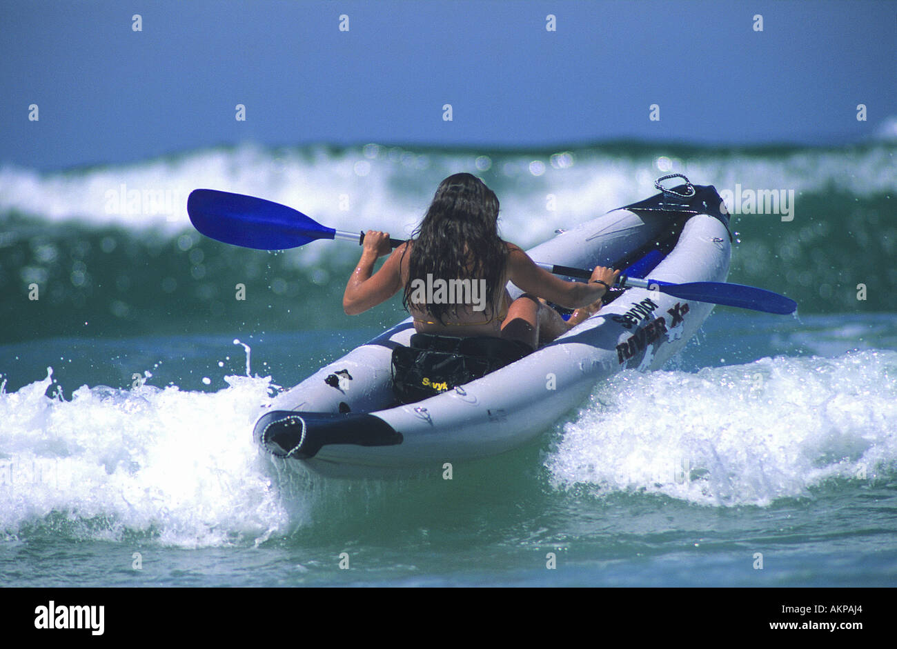 Female Sea kayaking into wave Stock Photo - Alamy