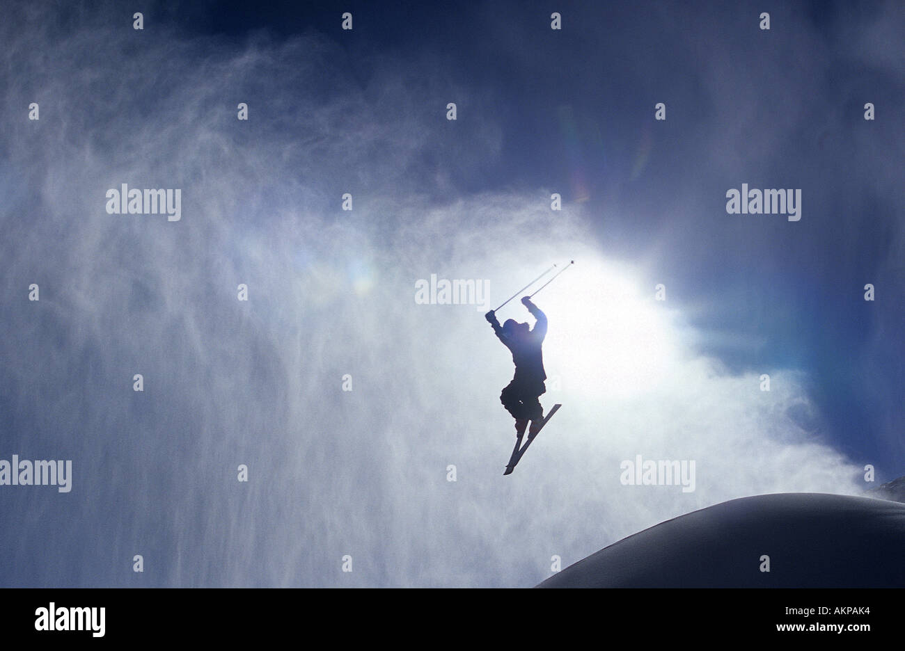 Skier flying through snow Stock Photo - Alamy