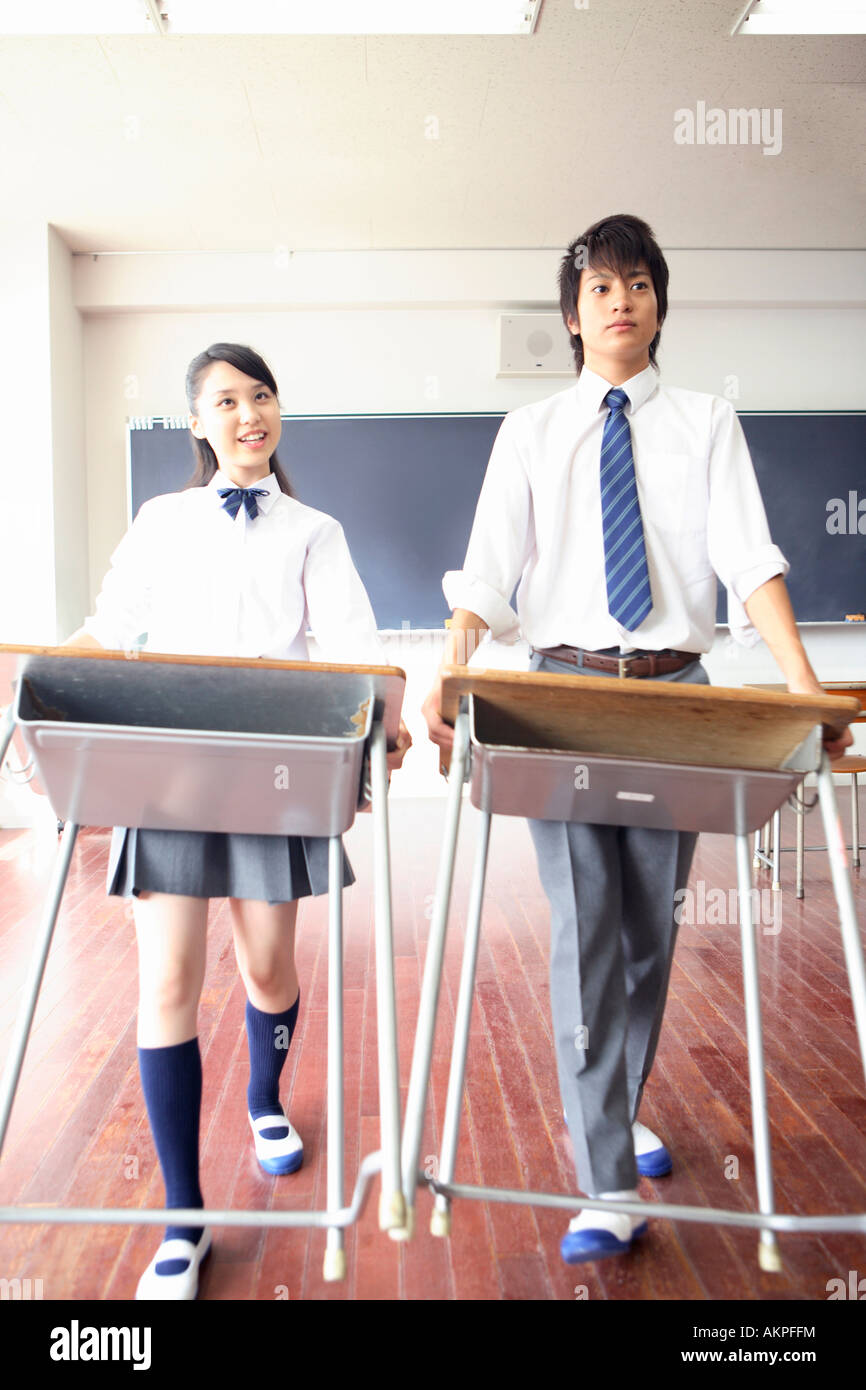 High school students putting chairs away Stock Photo - Alamy