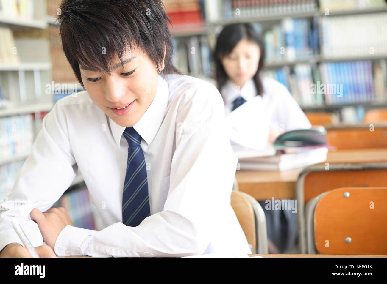 High school boy studying in a library Stock Photo - Alamy