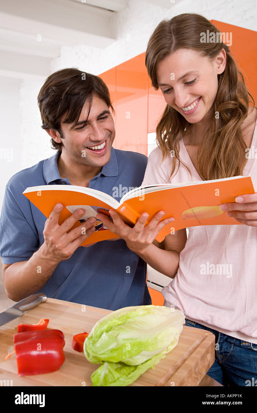 A couple reading a cookbook Stock Photo - Alamy