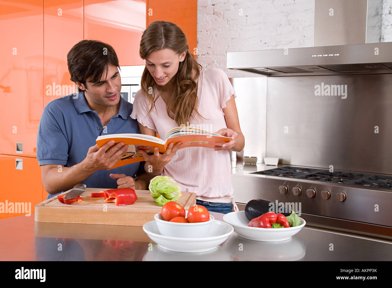 A couple reading a cookbook Stock Photo - Alamy