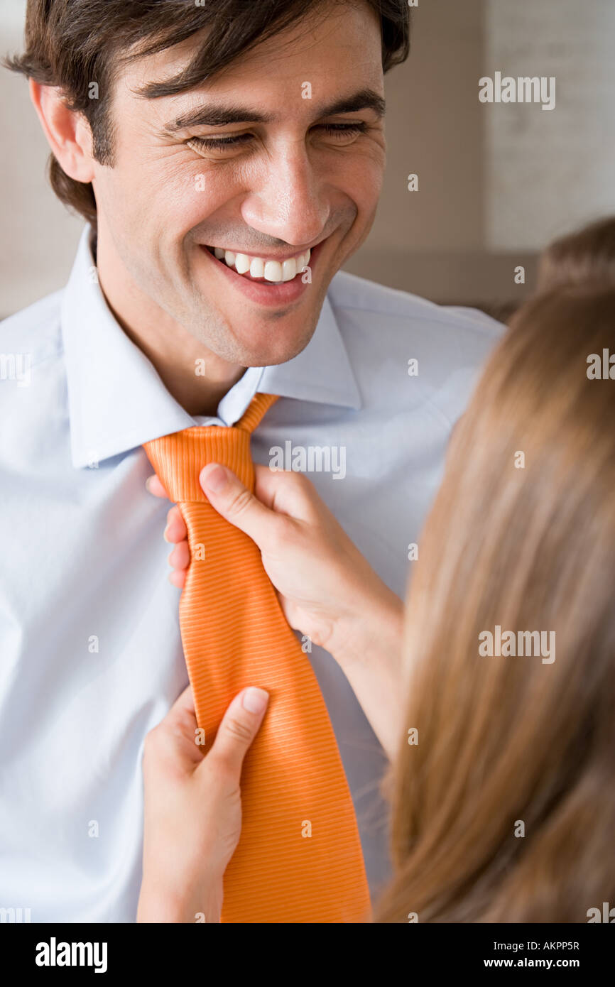 Woman tying man's tie hi-res stock photography and images - Alamy