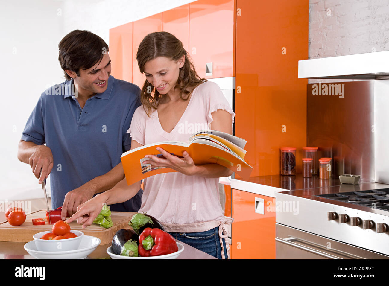 A couple reading a cookbook Stock Photo - Alamy