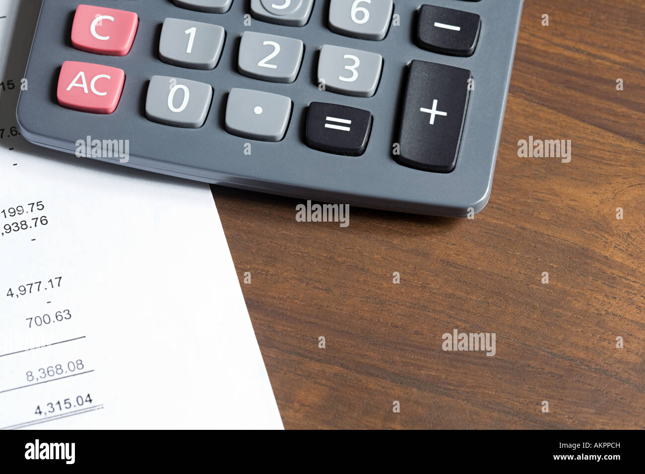 A calculator and paper work Stock Photo - Alamy
