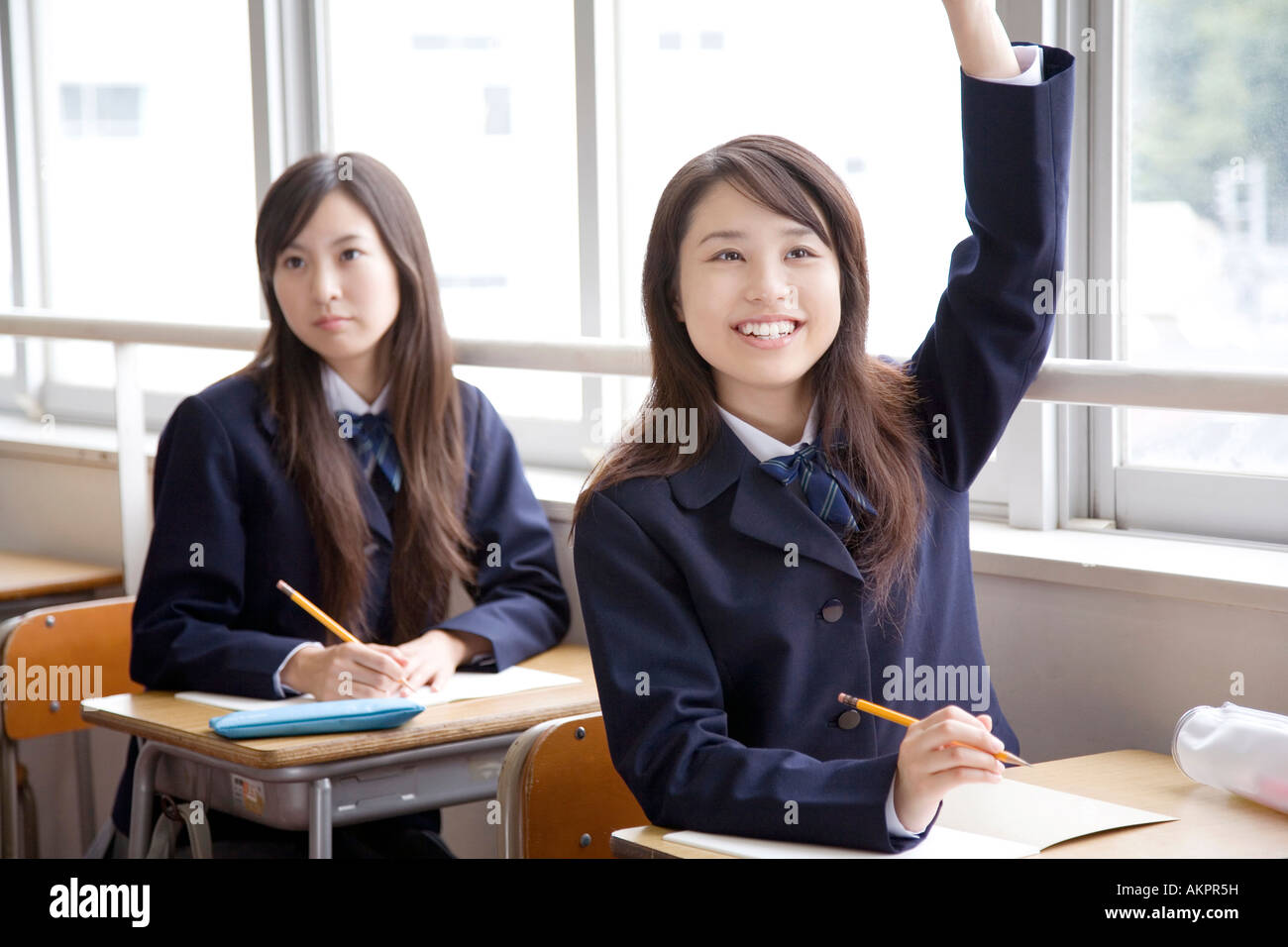 High school girl raising a hand Stock Photo - Alamy