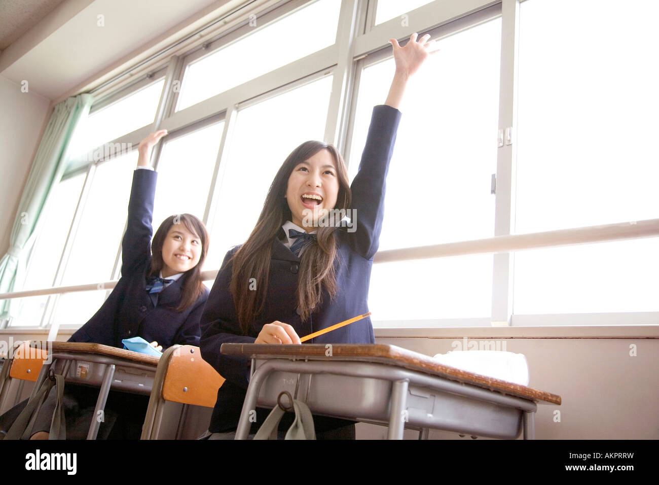 High school girl raising a hand Stock Photo - Alamy