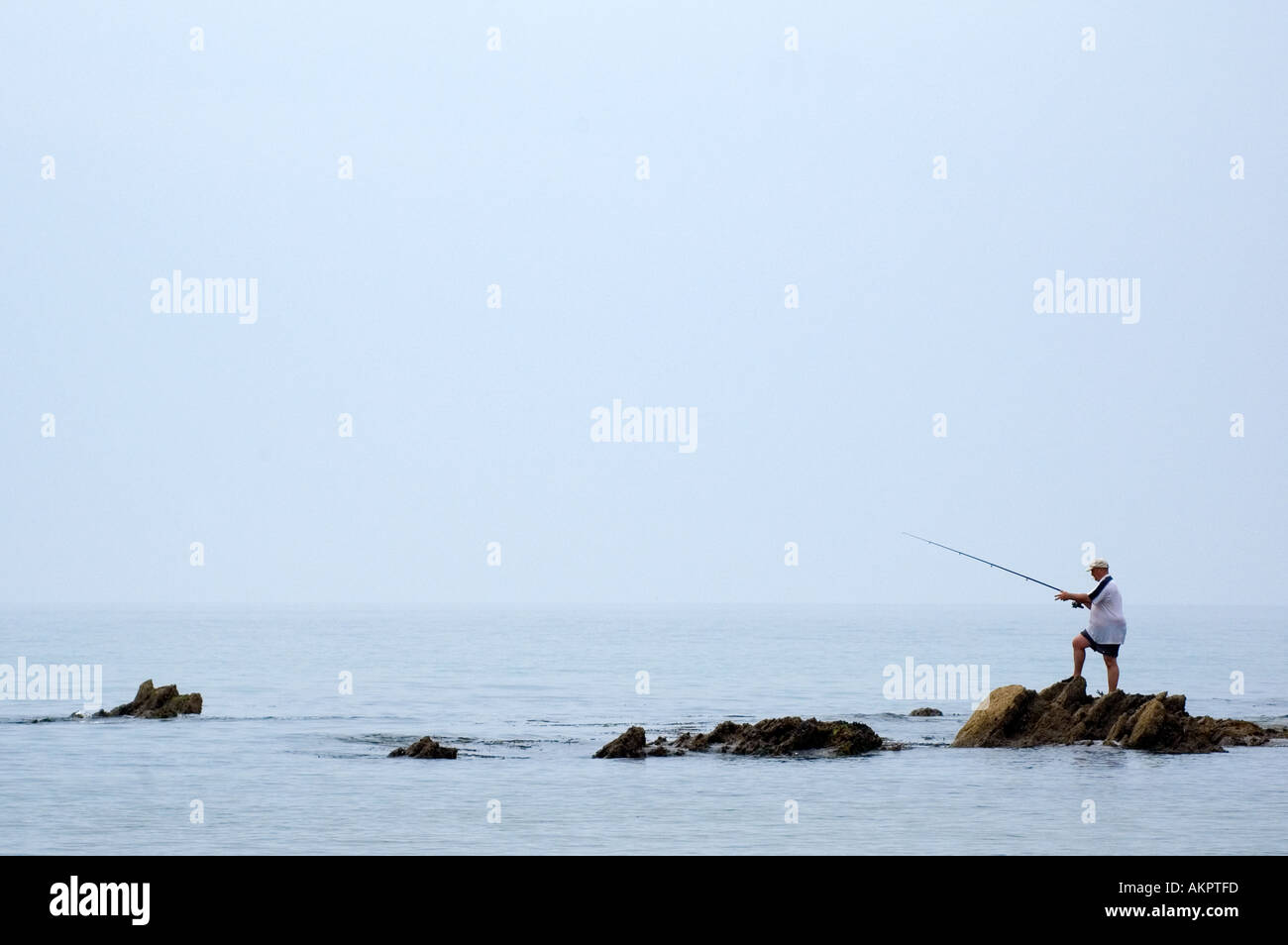 Man sea fishing angling off rocks hi-res stock photography and images ...