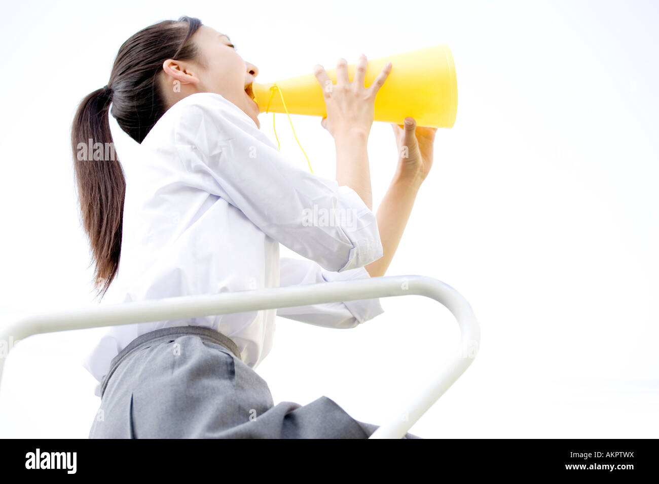 High school girl cheering with a megaphone Stock Photo - Alamy