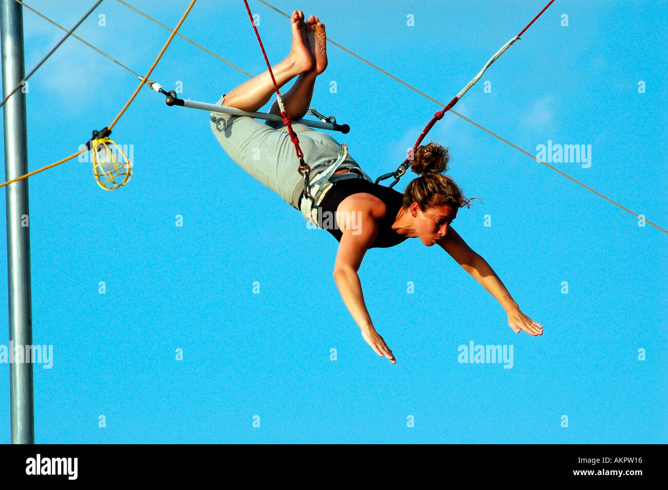 People swing on the trapeze at The Trapeze School at Hudson River Park ...