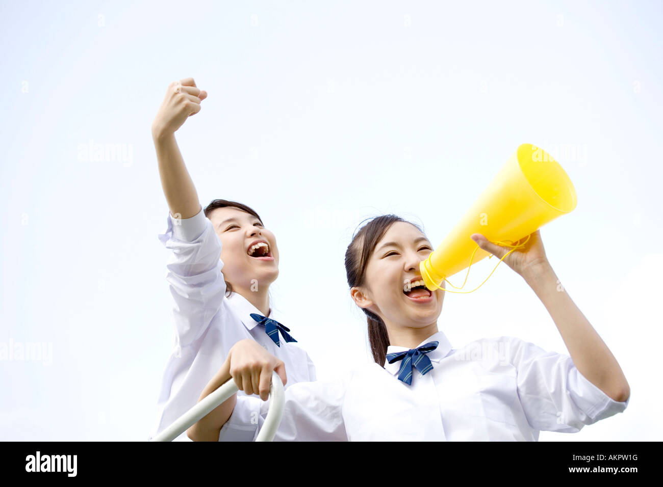 High school girl cheering with a megaphone Stock Photo - Alamy