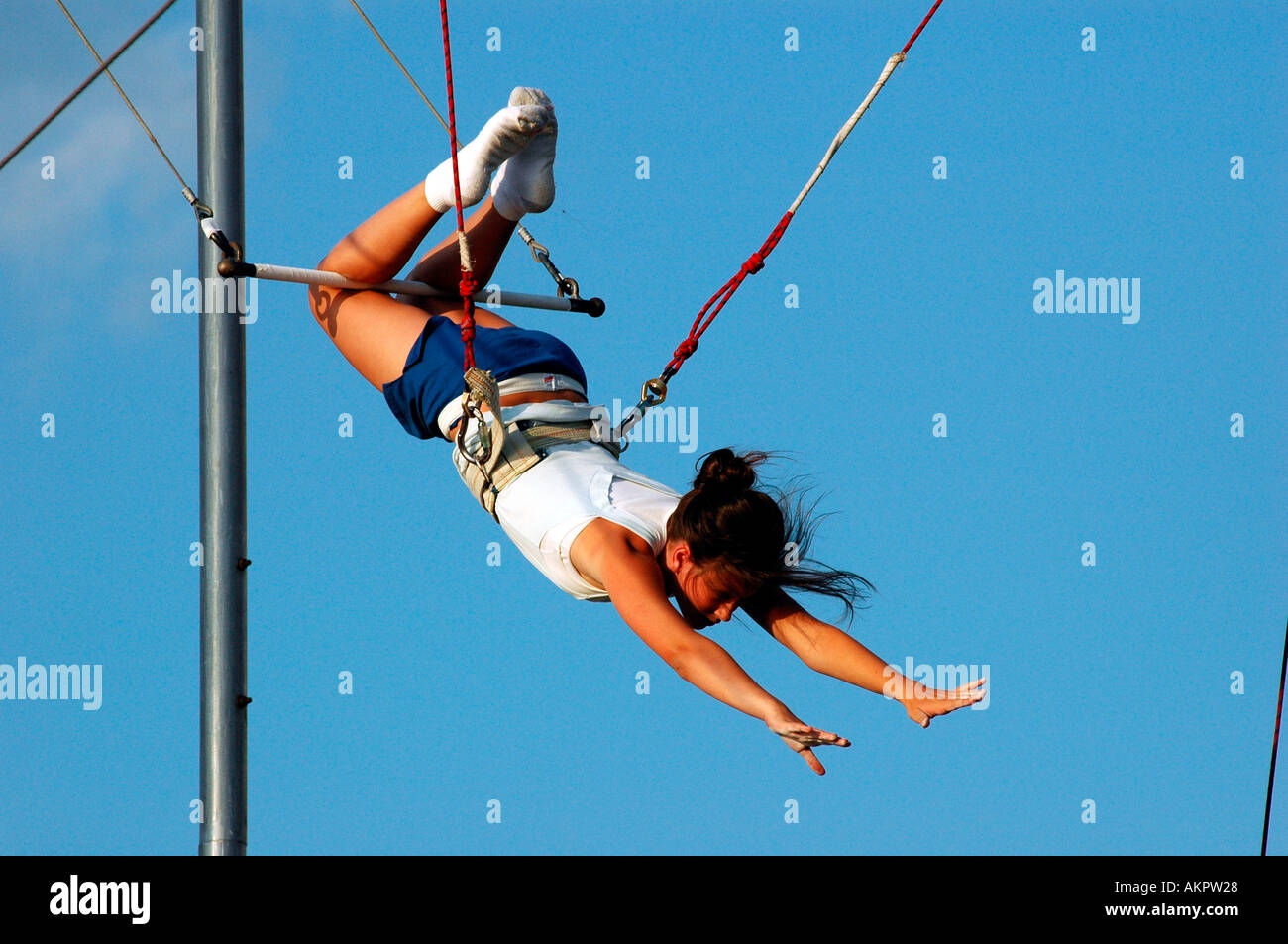 People swing on the trapeze at The Trapeze School at Hudson River Park ...