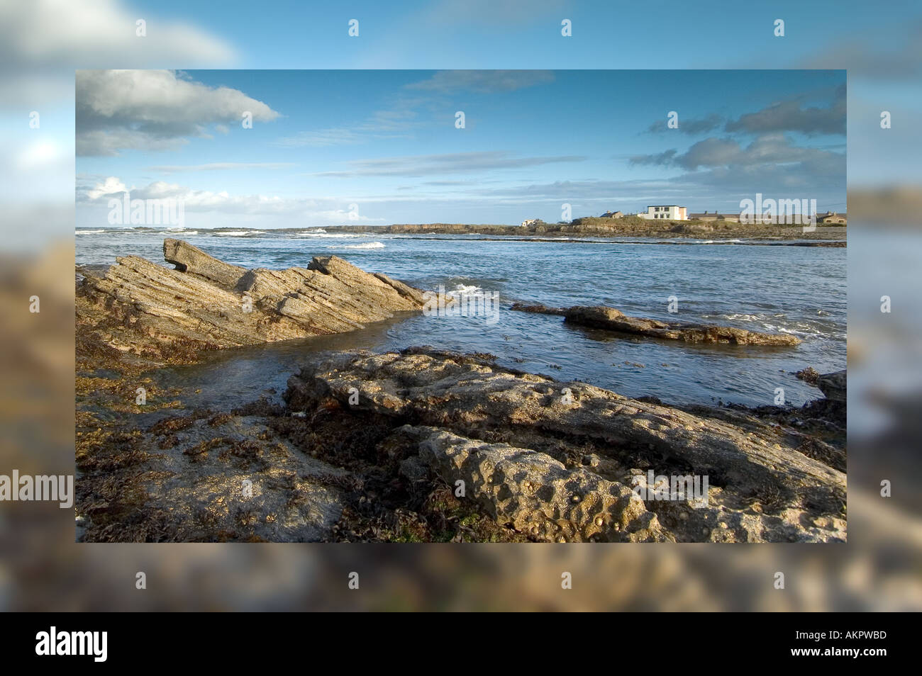 Sun Lit Rocks In Beadnell Bay Stock Photo - Alamy