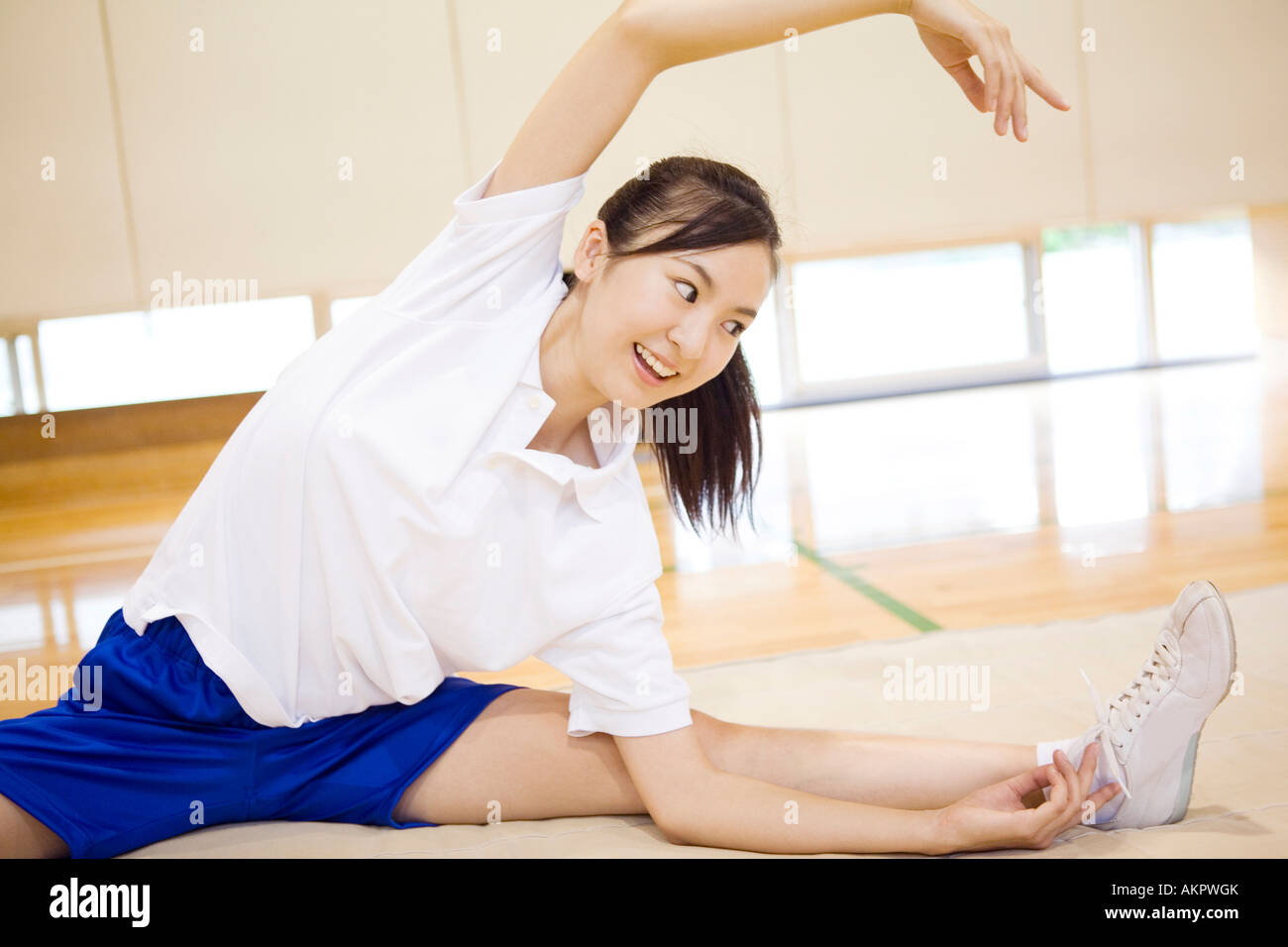 High school girl doing a warm-up Stock Photo - Alamy