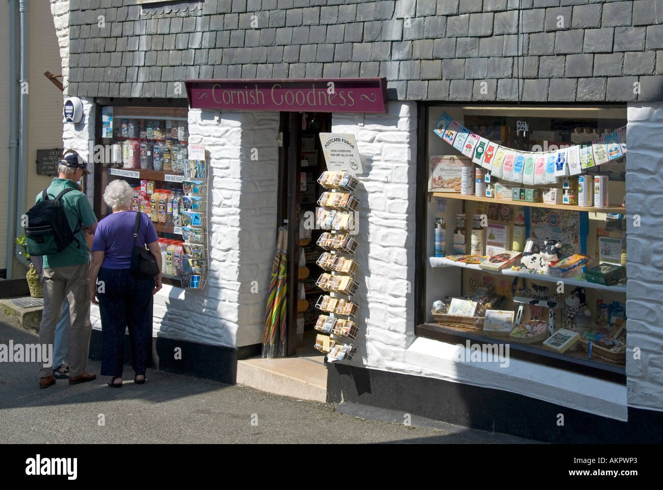 Older tourist couple window shopping & looking at sweet shop named ...