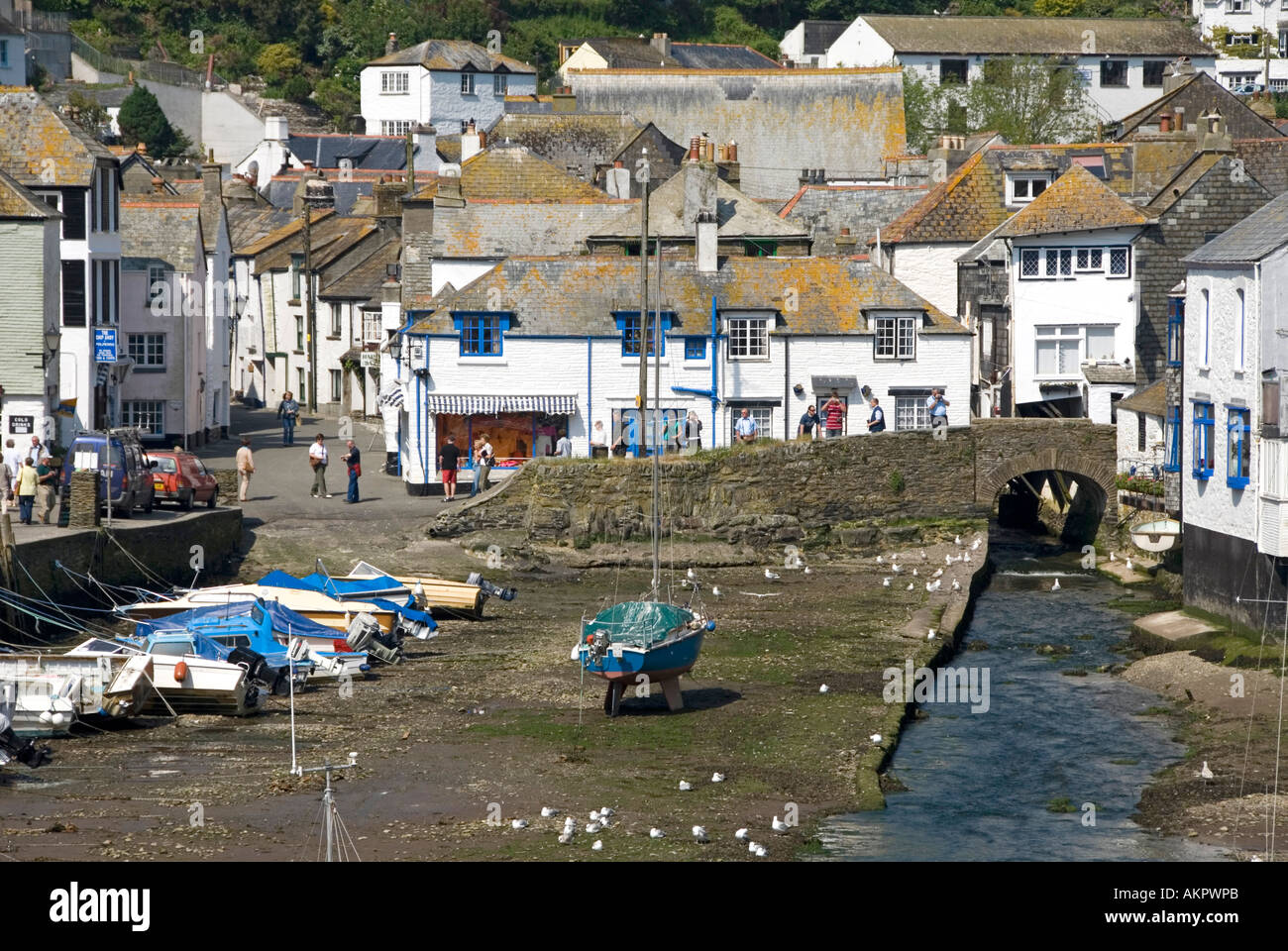 Summer tourists around village shops on narrow stone bridge with River ...