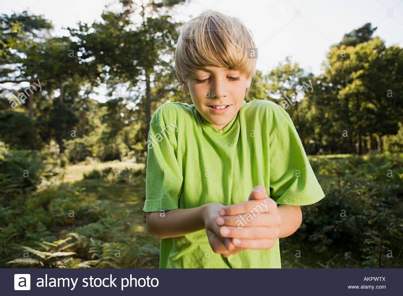 Boy Holding Something In Hands Stock Photos & Boy Holding Something In ...