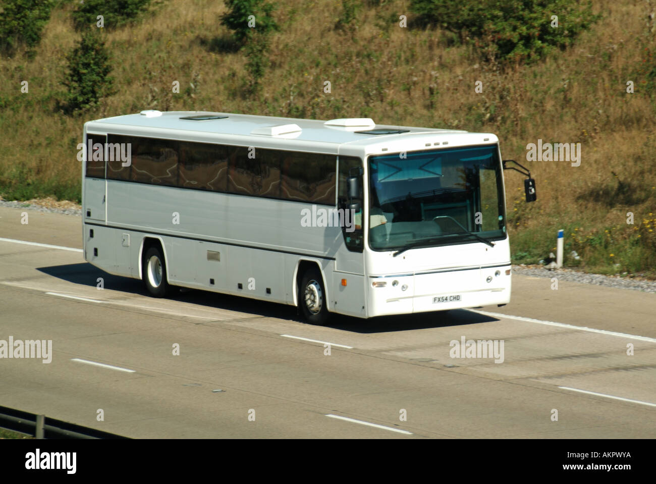 M25motorway white unmarked holiday coach with dark windows Stock Photo ...