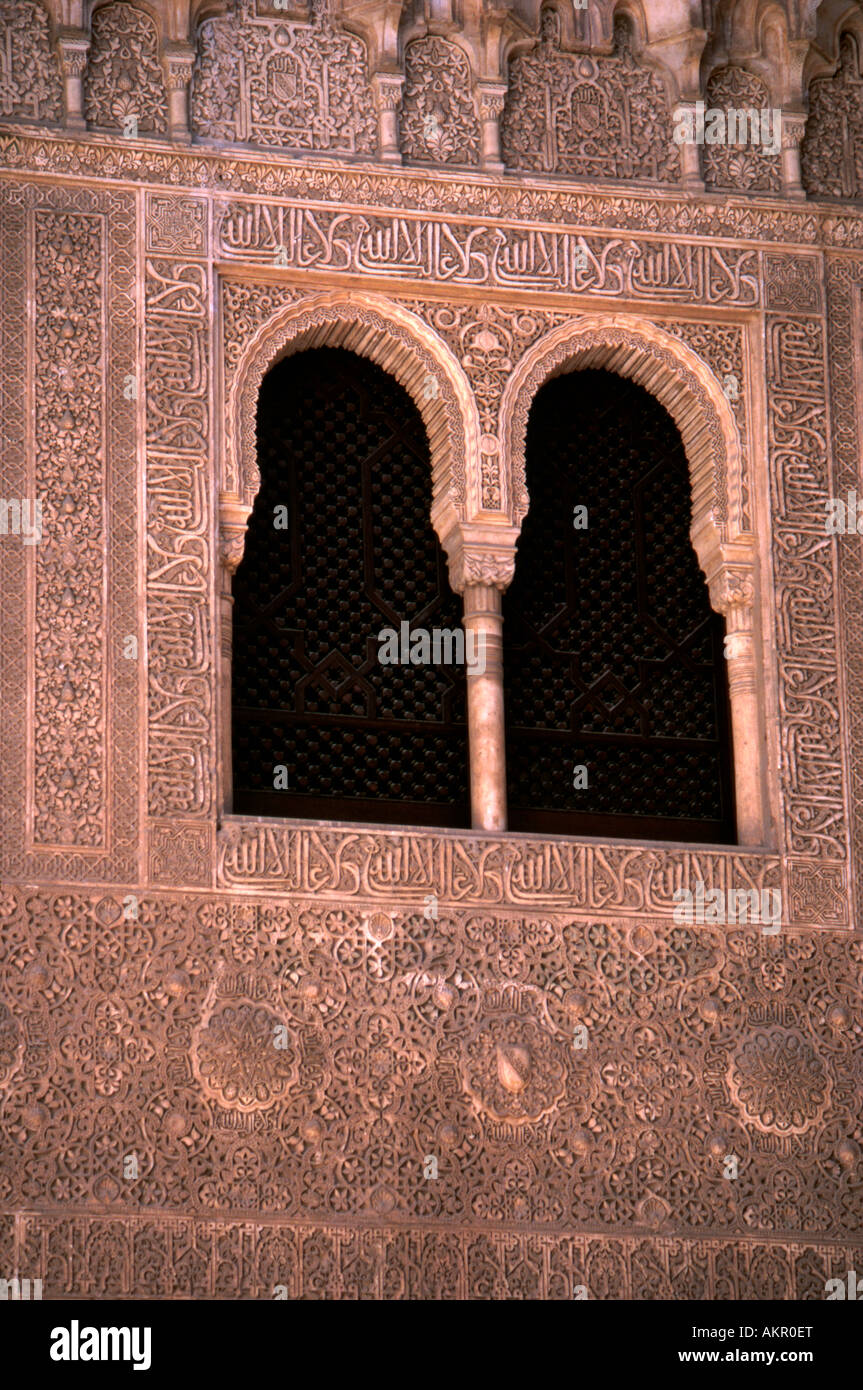 A detail of stucco carving and a window in the Patio de los Cuarto ...
