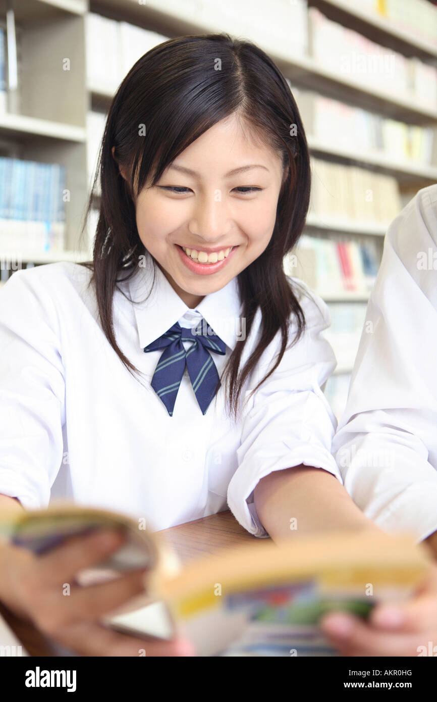 High school girl in a library Stock Photo - Alamy