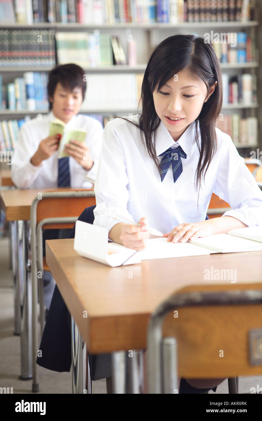 High school girl studying in a library Stock Photo - Alamy