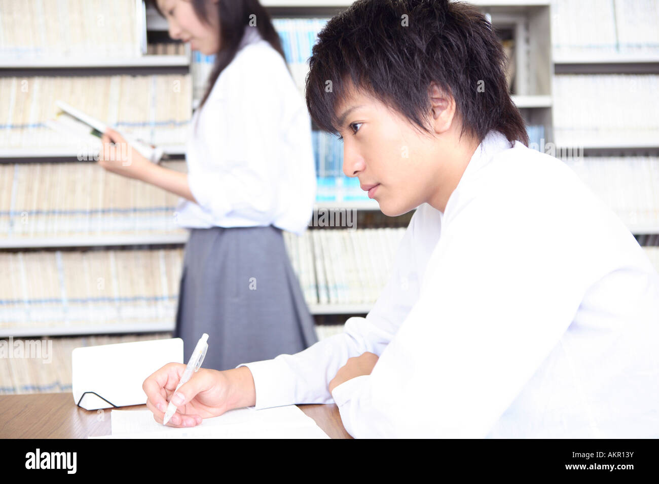 High school boy studying in a library Stock Photo - Alamy