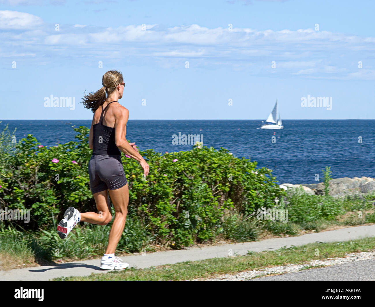 Woman jogging near beach hi-res stock photography and images - Alamy