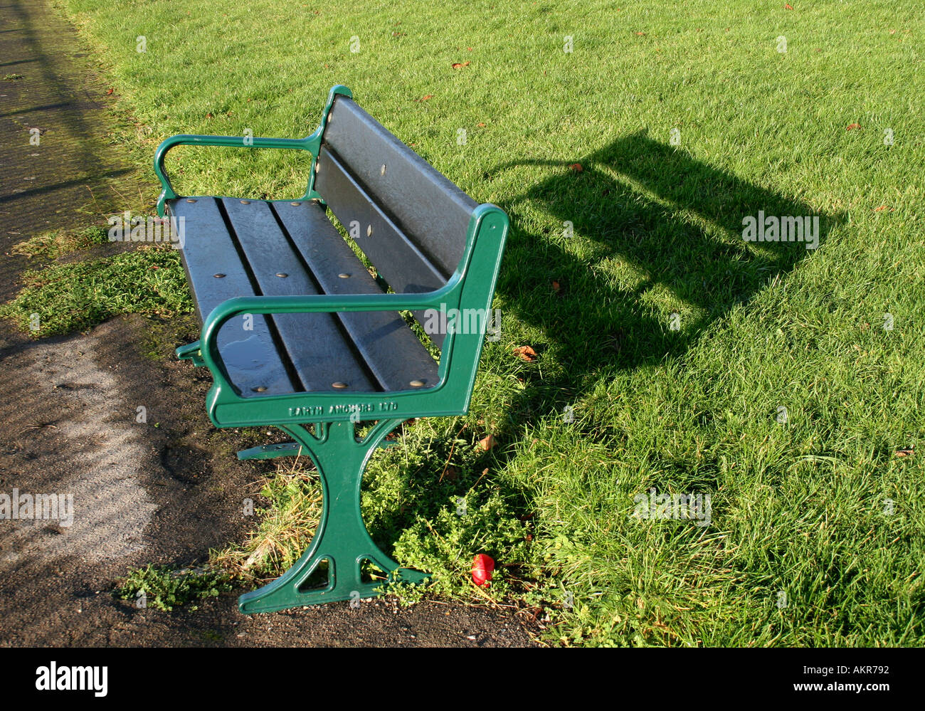 Park bench with shadow Stock Photo - Alamy
