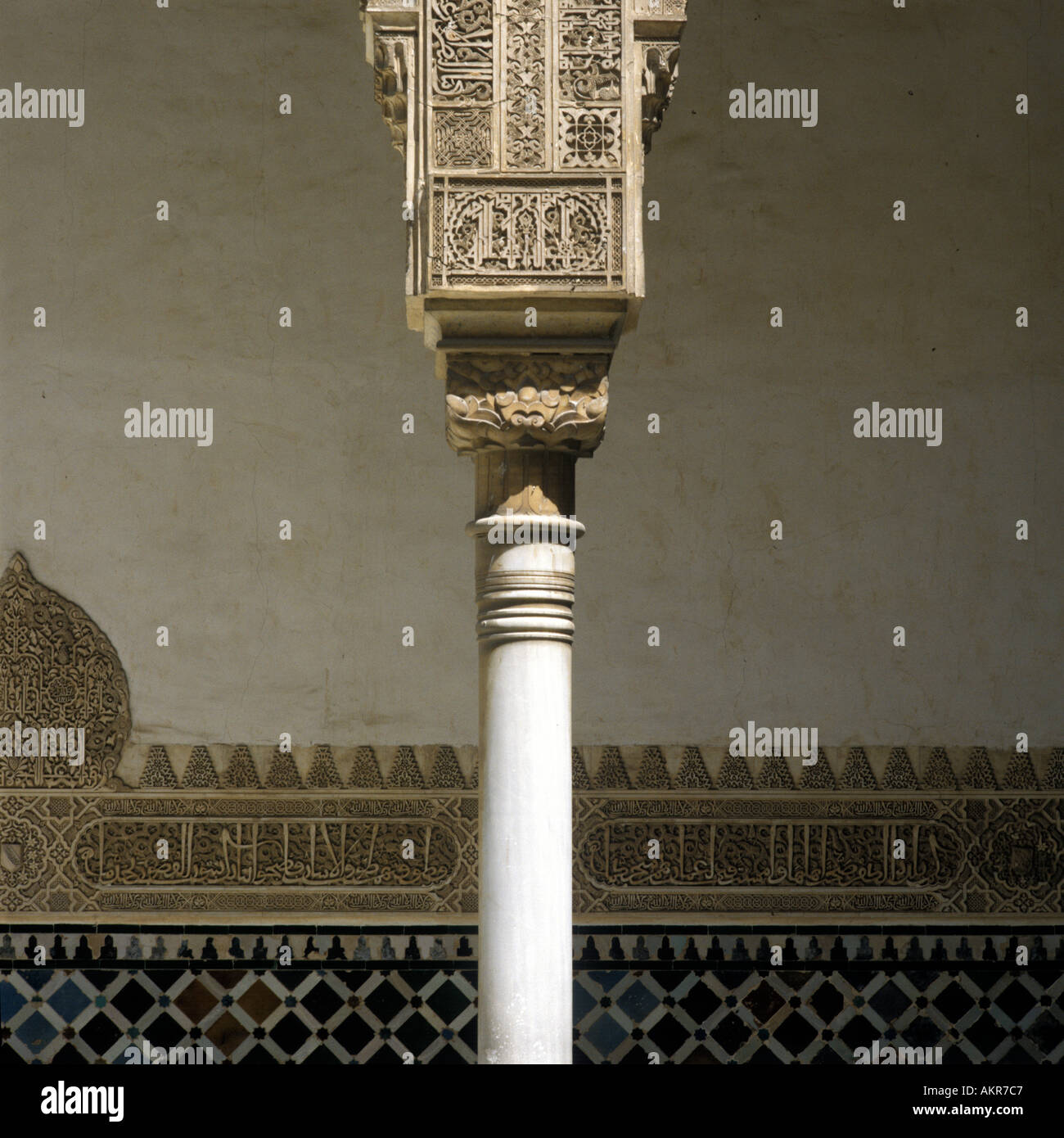 Single slender moorish column with ornate stone carved capital and arch ...