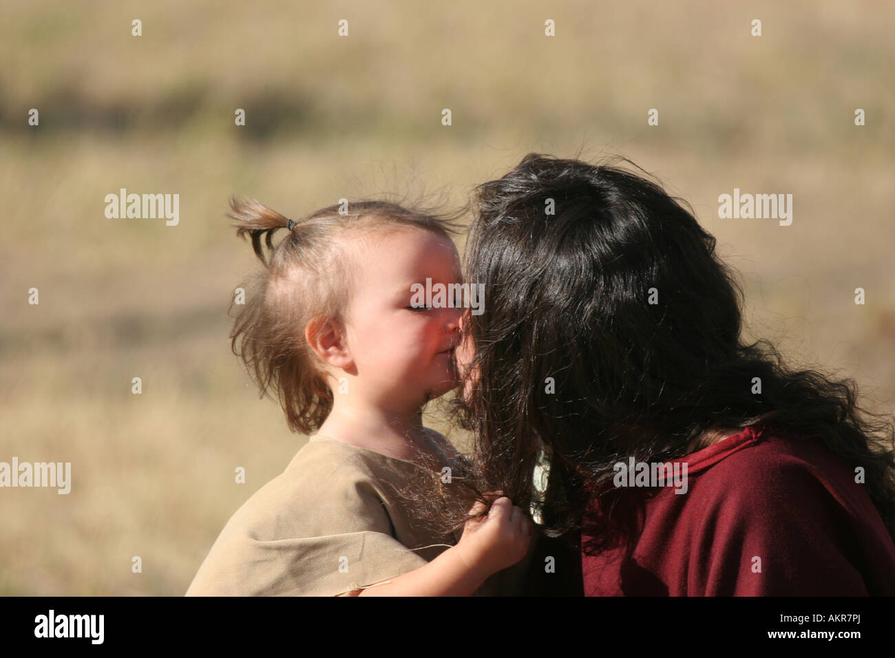 A Native American Indian mother kissing her daughter Stock Photo - Alamy