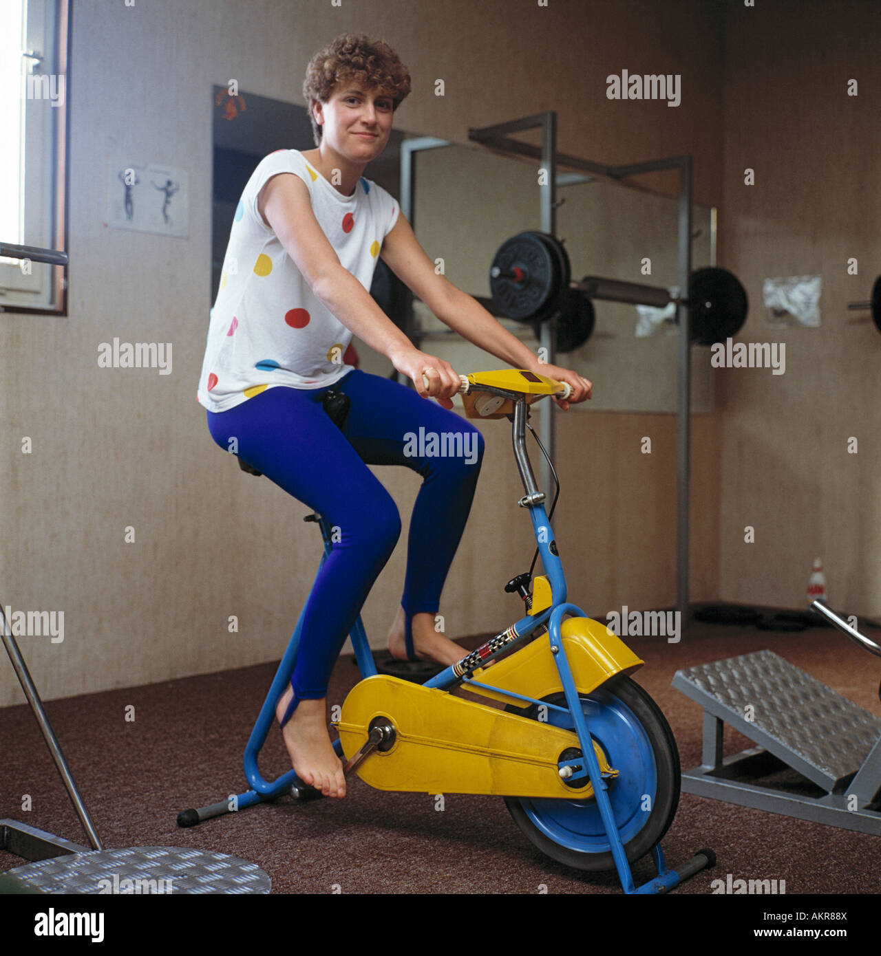 girl makes stamina training on a bicycle, gymnastics, young woman ...