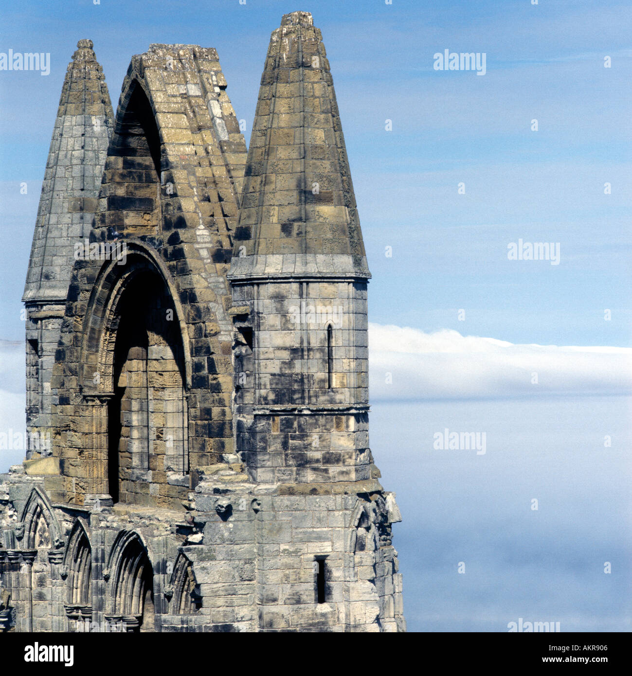 High view of North Transept gable and turrets of Whitby Abbey with sea ...