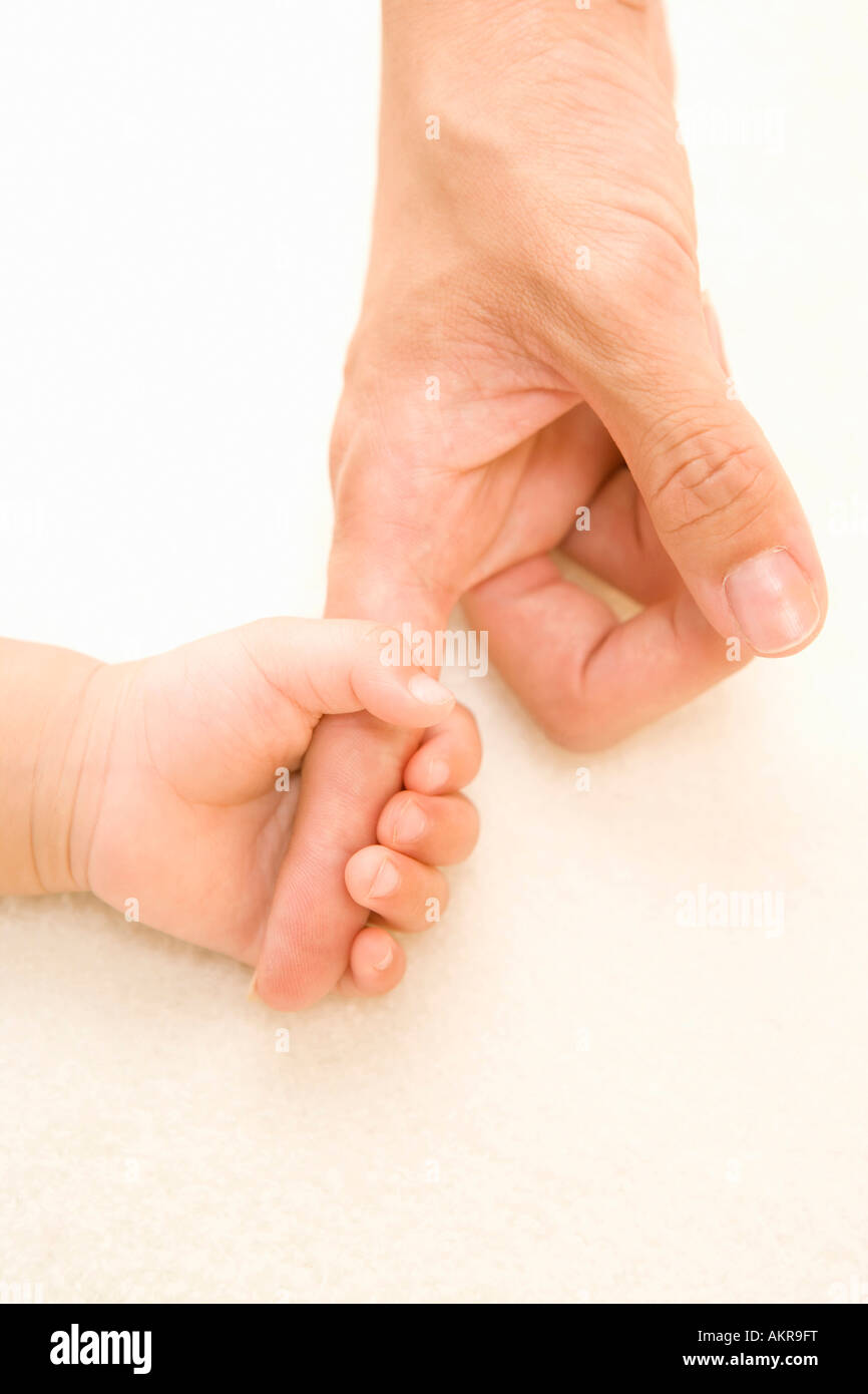Baby touching his father's finger Stock Photo - Alamy
