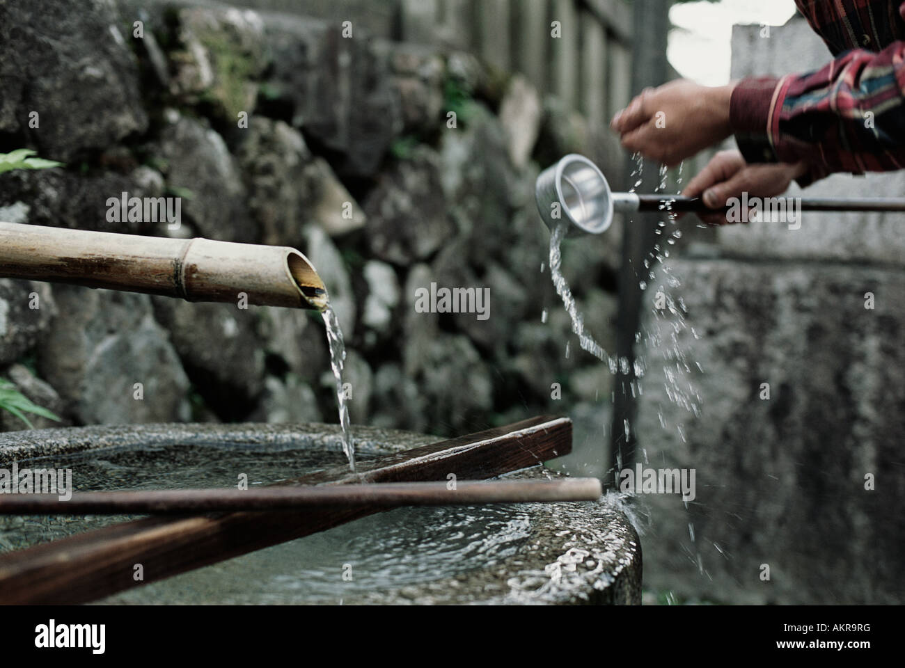 Person with water at temple Stock Photo - Alamy