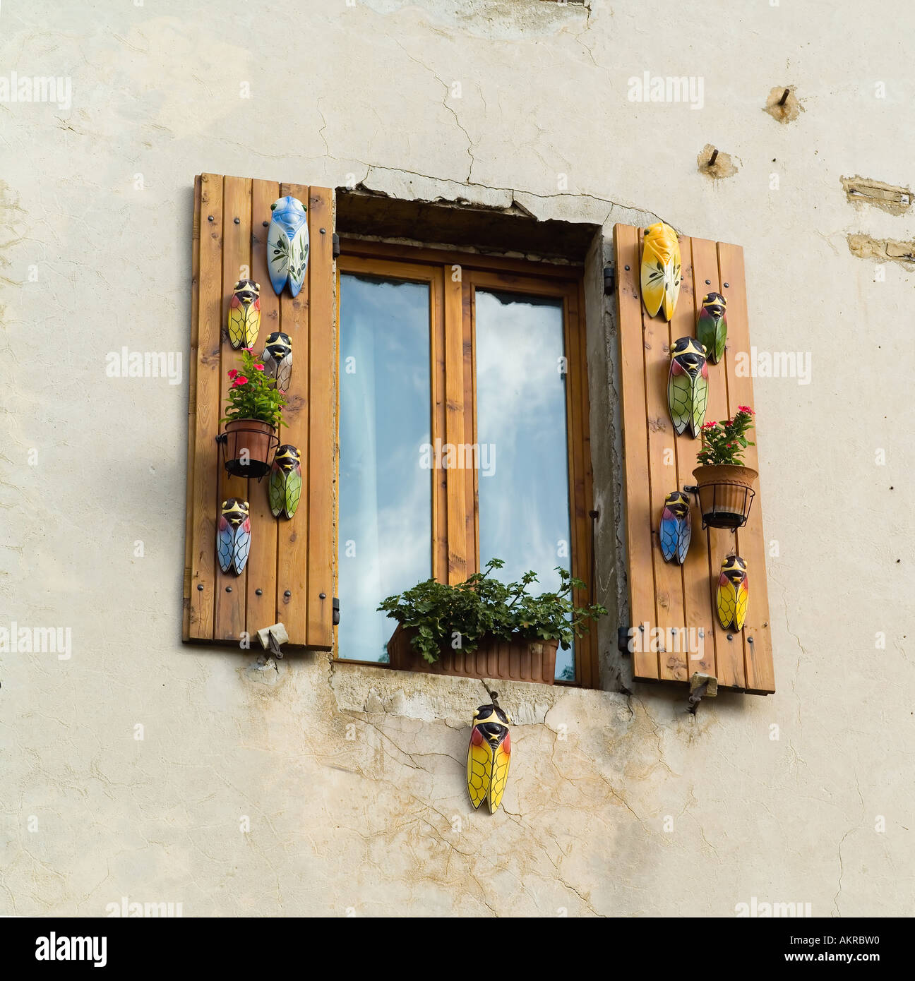 Pieces of pottery, earthenware cicadas displayed on shutters, window ...