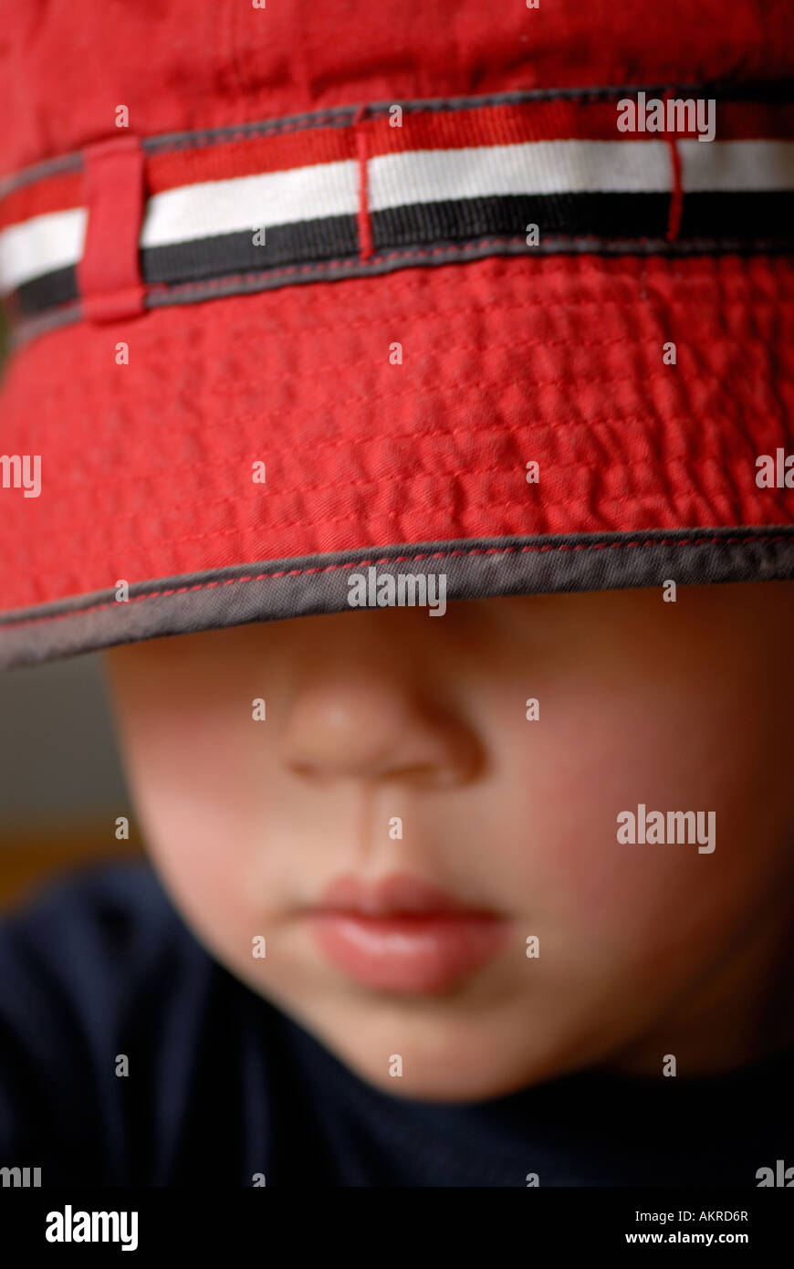 child hiding behind his hat portrait Stock Photo - Alamy