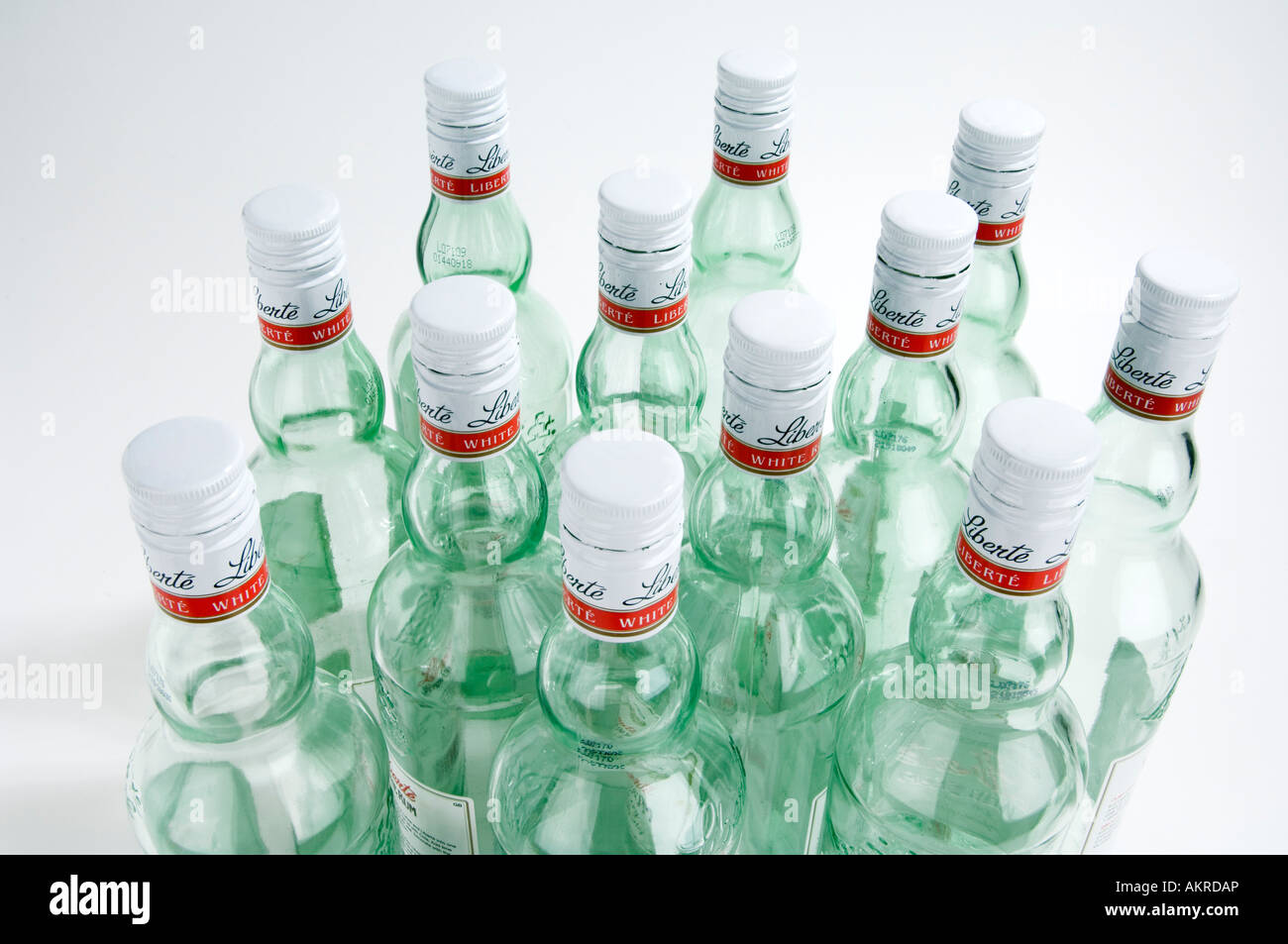 A group of empty spirit bottles on a white background Stock Photo - Alamy