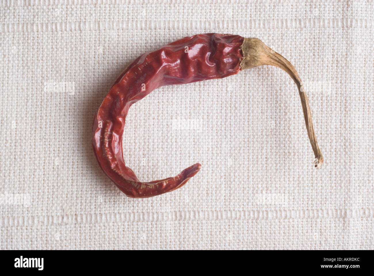 Curved Red Hot Chili Pepper on Table Cloth Stock Photo - Alamy