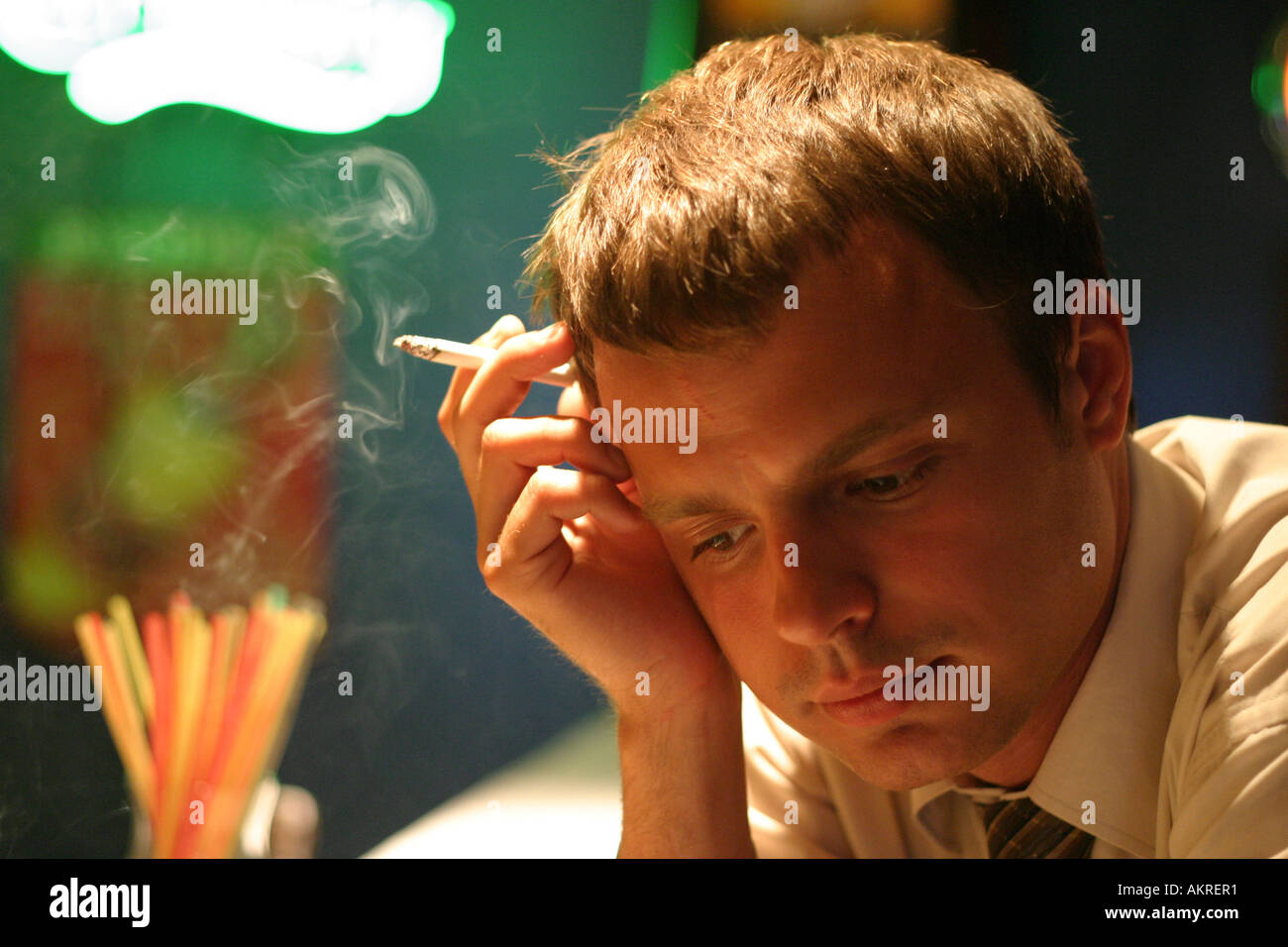 Young man smoking in the bar Stock Photo - Alamy