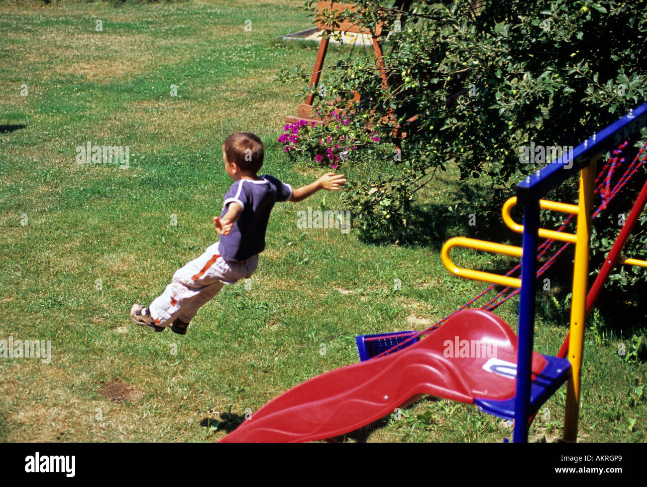 Boy jumping from a swing seesaw, danger Stock Photo - Alamy
