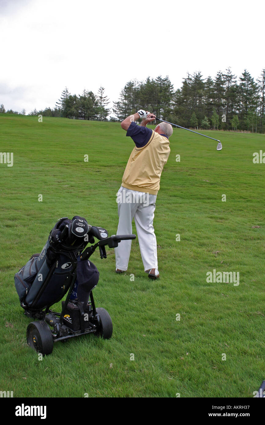 golfer hitting a ball on the fairway onto the green up a slope Stock ...