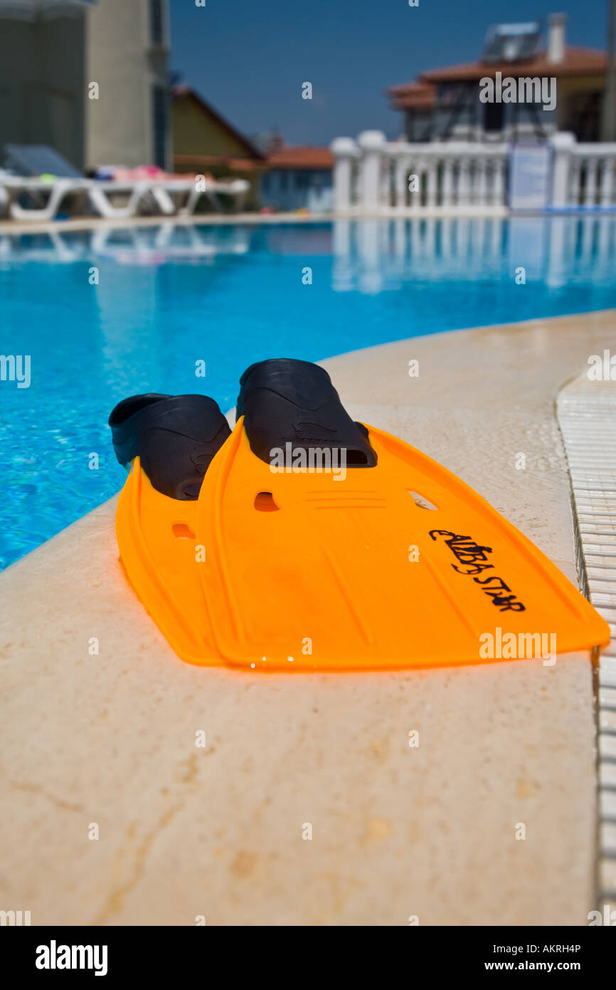 Flippers lying on the side of a swimming pool Stock Photo - Alamy