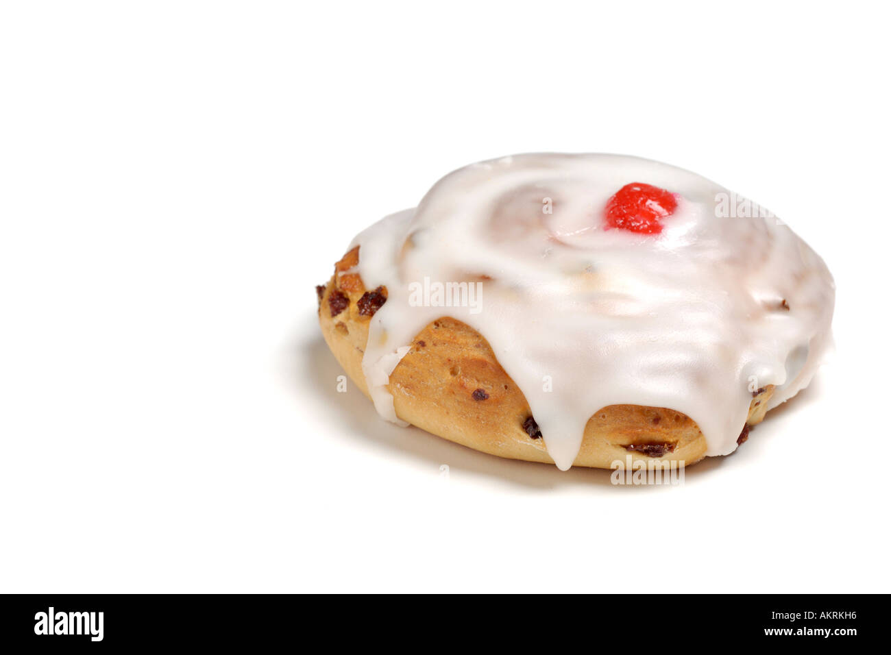 Sticky iced bun with cherry Stock Photo - Alamy