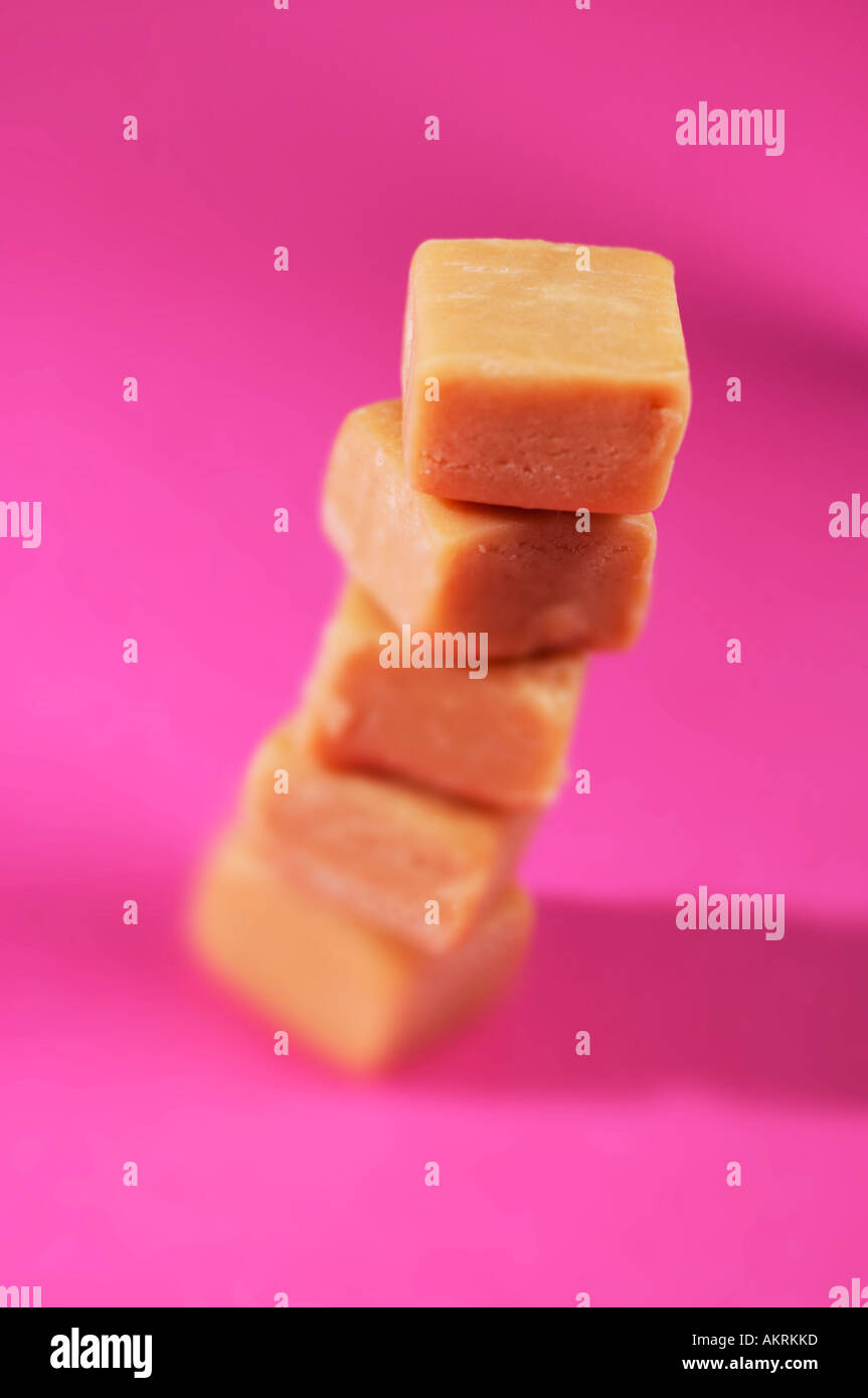 Stack of fudge squares against pink background Stock Photo - Alamy