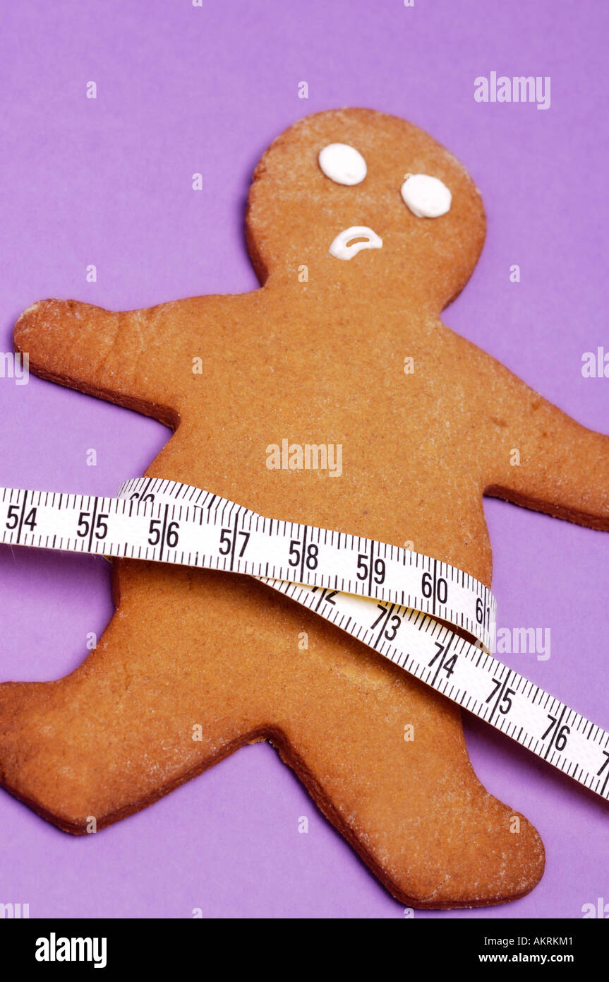 Gingerbread man with tape measure around waist Stock Photo - Alamy