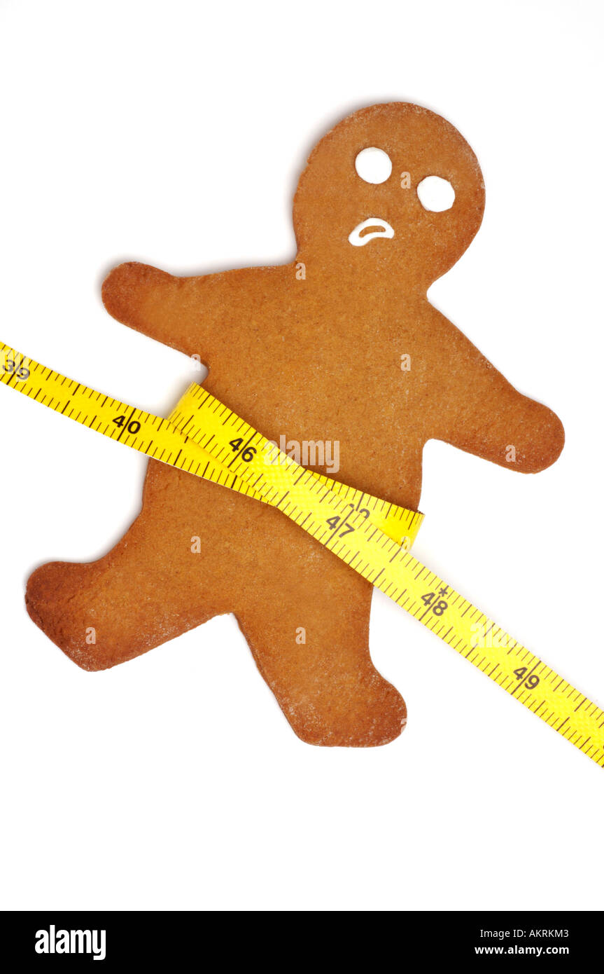 Gingerbread man with tape measure around waist Stock Photo - Alamy